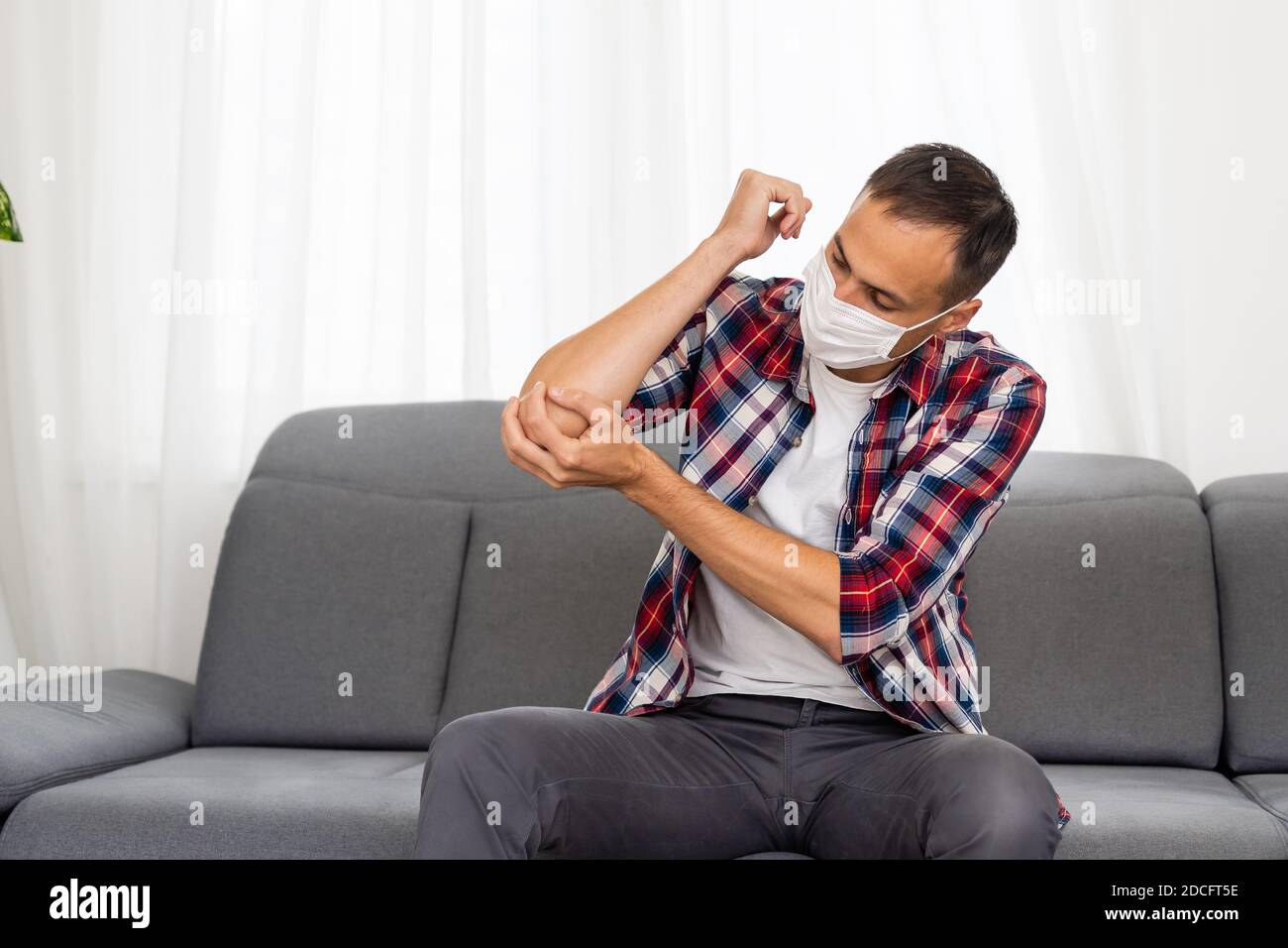 Caucasian handsome man wear masks and hold hand on his chest ...