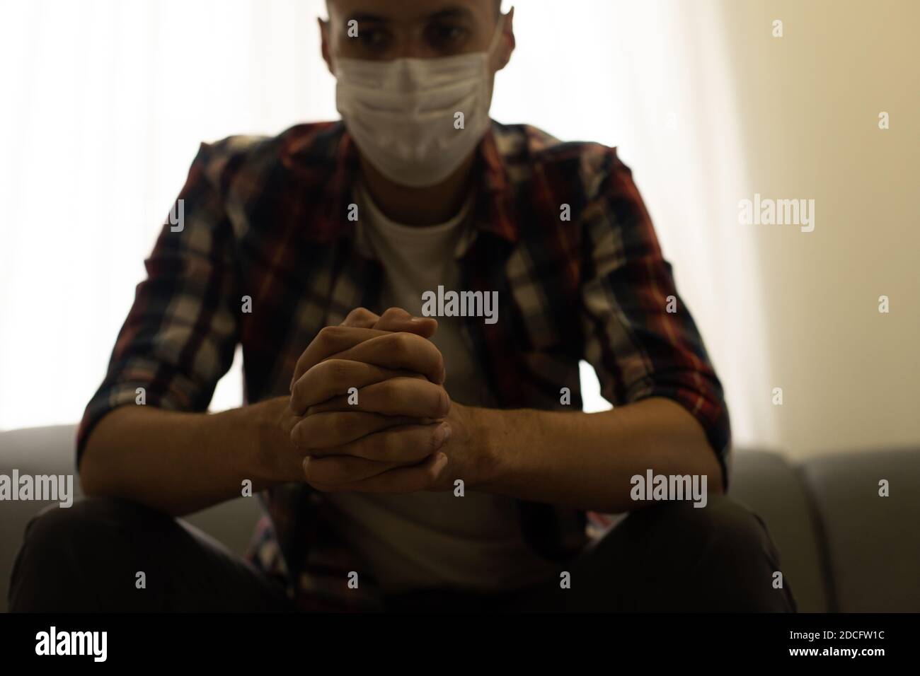 Sad man touches his face with his hand. He's desperate. He wears ...