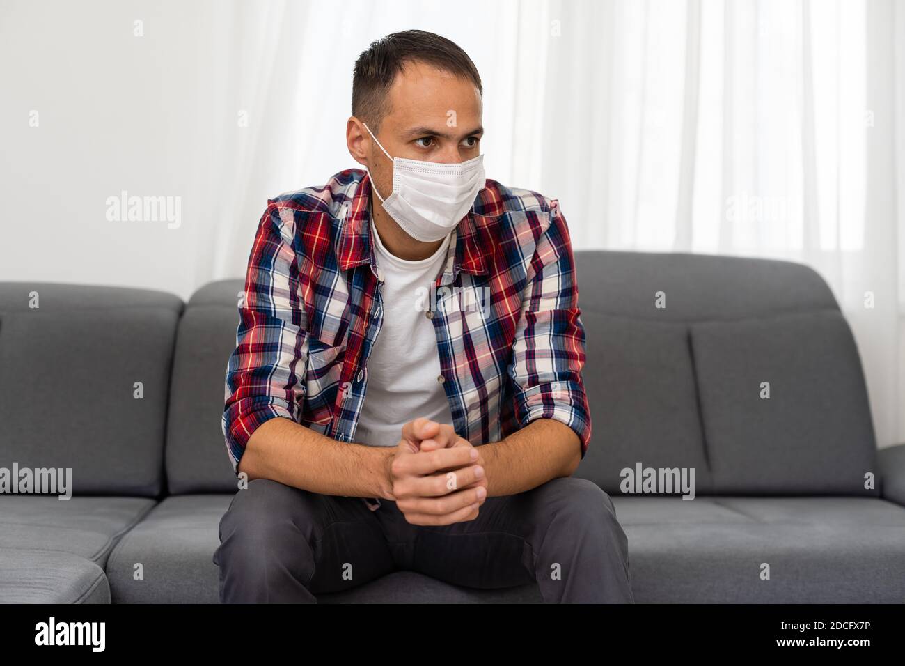 Sad man touches his face with his hand. He's desperate. He wears ...