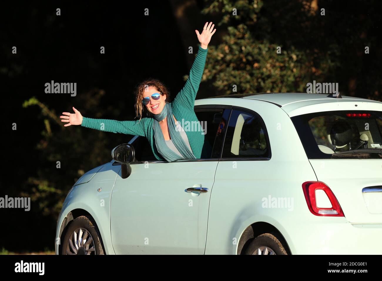 woman outside the windows car with open arms Stock Photo - Alamy