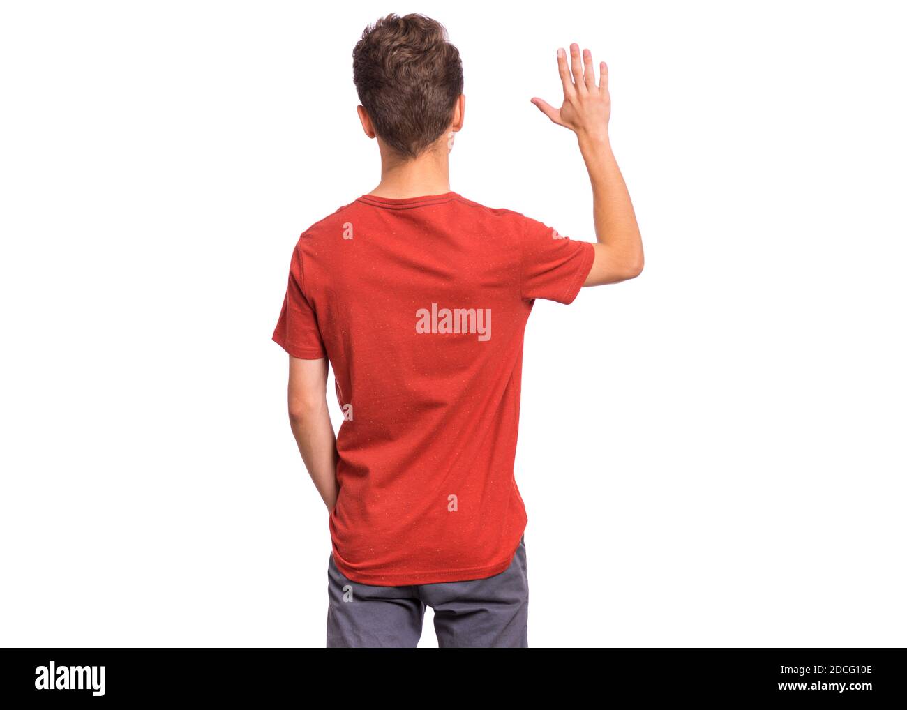 Handsome teen boy with his back turned to camera, pointing to something ...