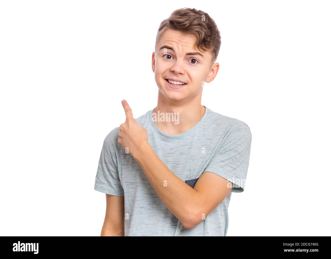 Cute teen boy pointing up, gesturing idea or doing number one gesture ...