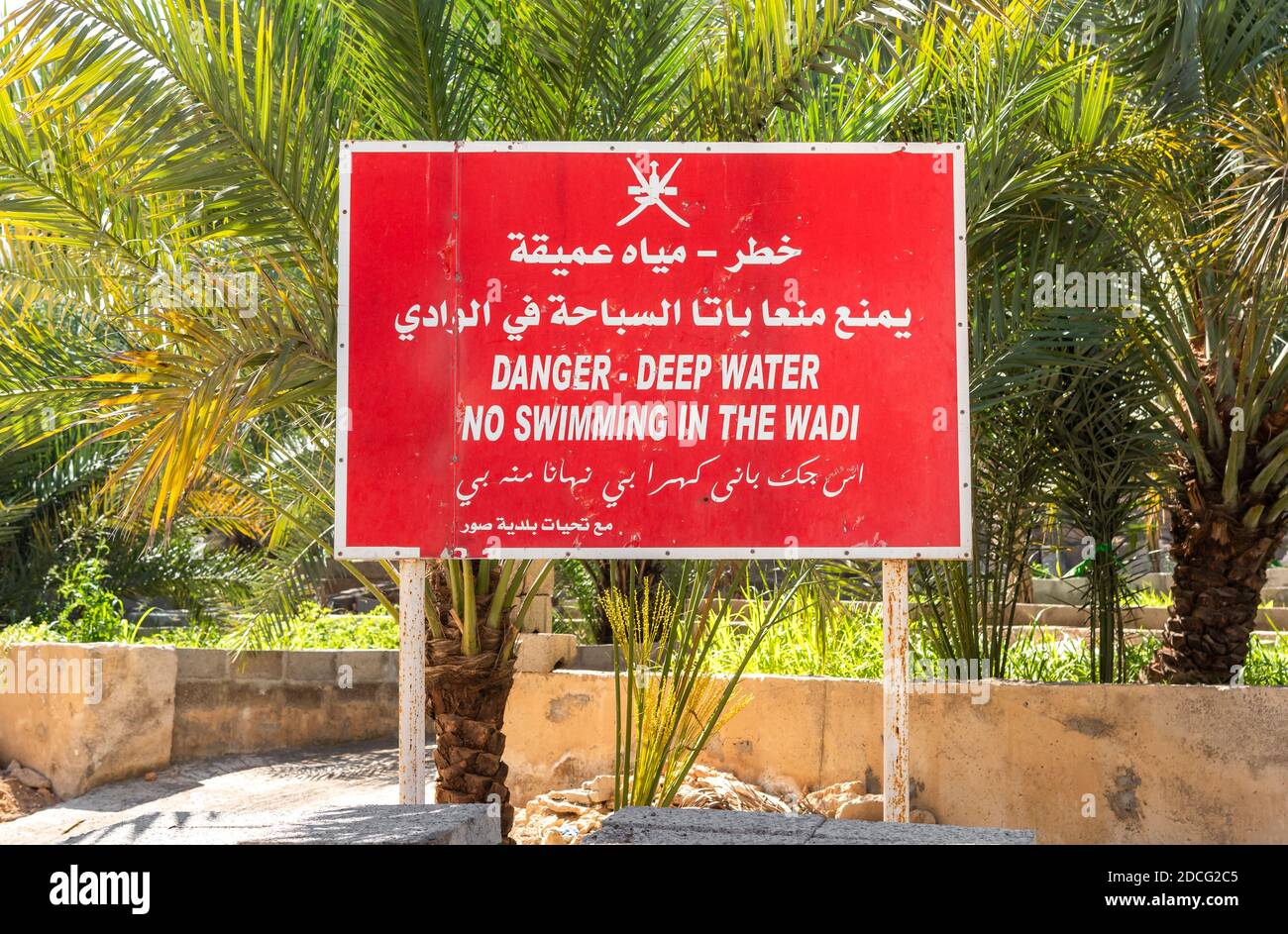 Danger - deep water and no Swimming sign in the Wadi, in Arabic and ...