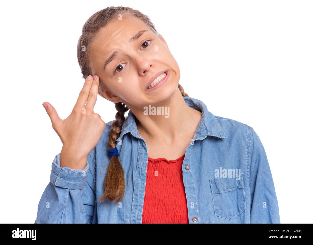 Beautiful teenage girl pointing hand and fingers to head like gun ...