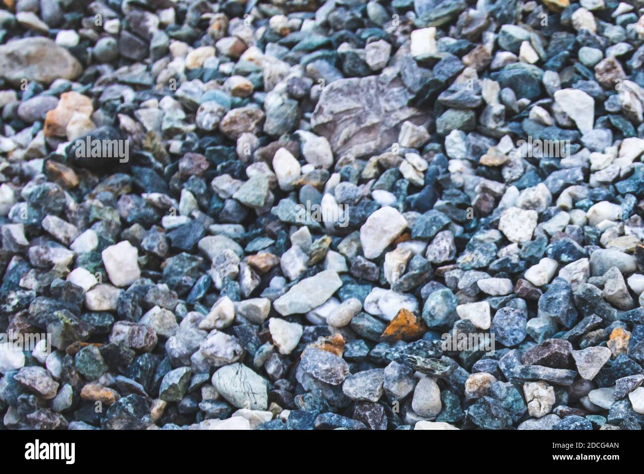 background of stones of various sizes and scattered colors Stock Photo ...