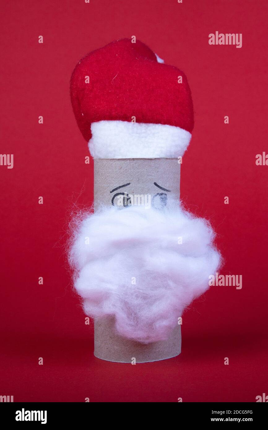 empty toilet roll with a sad face, red cap and beard, as a Santa Clause ...