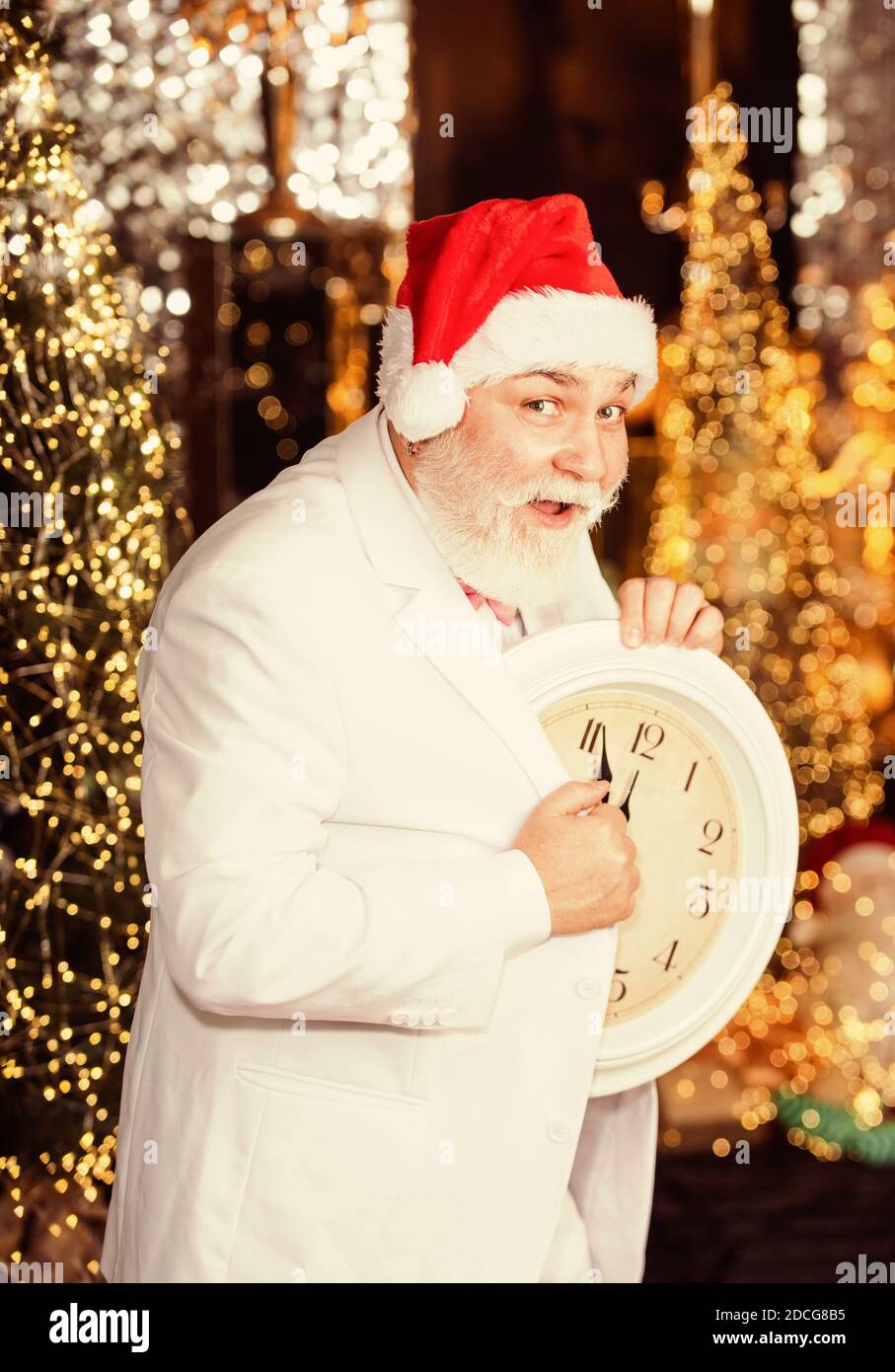 Celebrating New Year. wait for xmas presents. santa man hold alarm ...