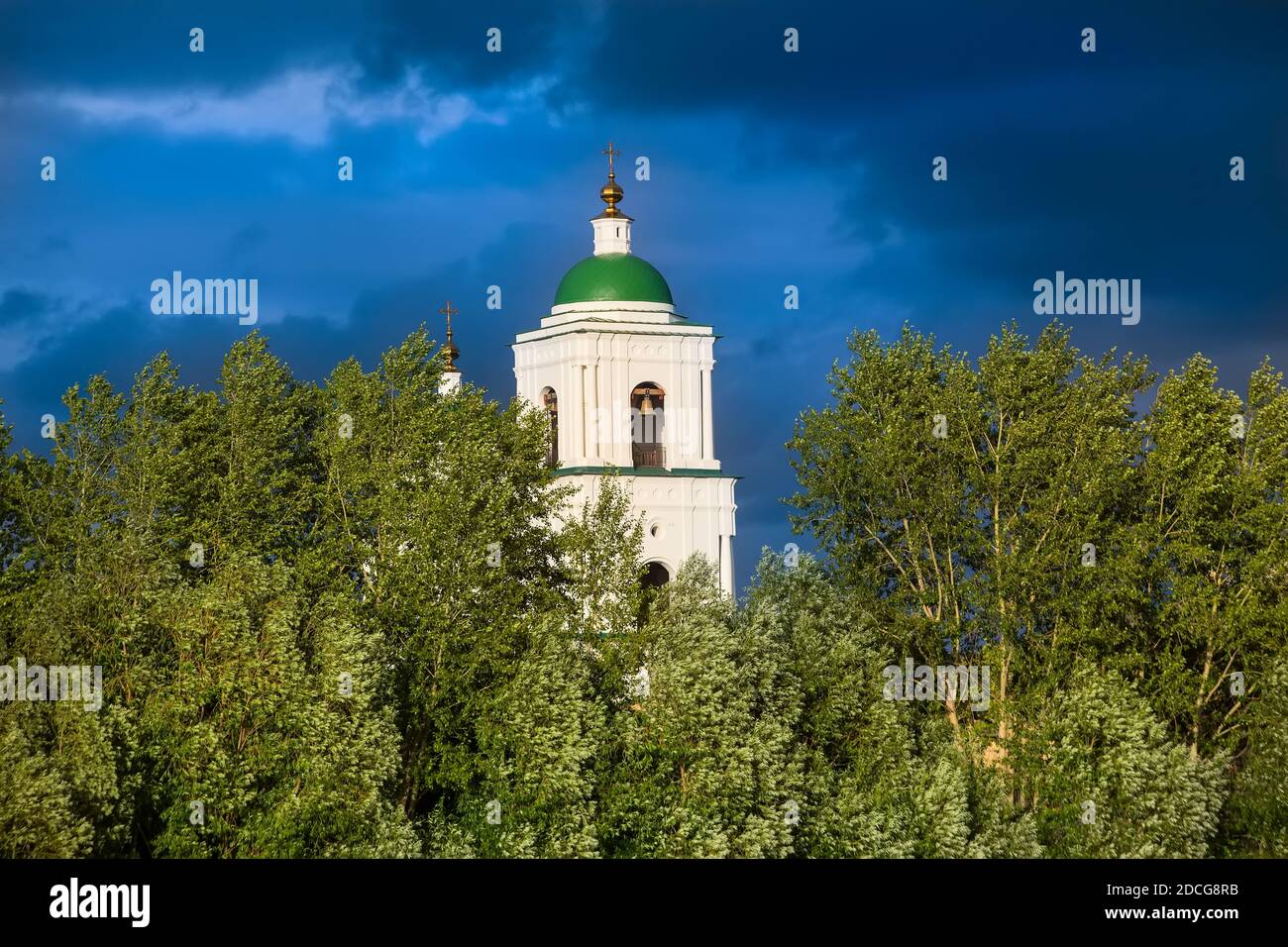 Bell tower of the orthodox church behind the trees Stock Photo - Alamy