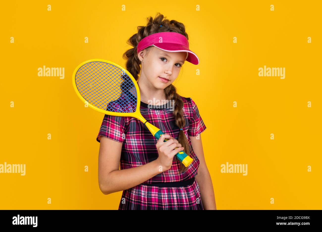 full of energy. happy childhood. kid in cap hold racket. child with ...