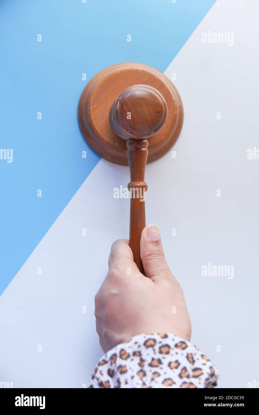 Top view of person's hand striking the gavel Stock Photo - Alamy