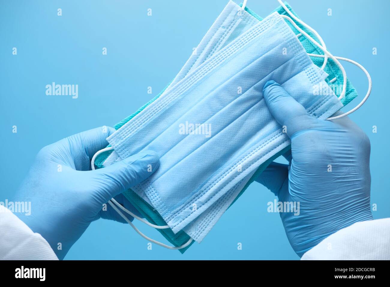 doctor hand in medical glove holding protective surgical face mask ...