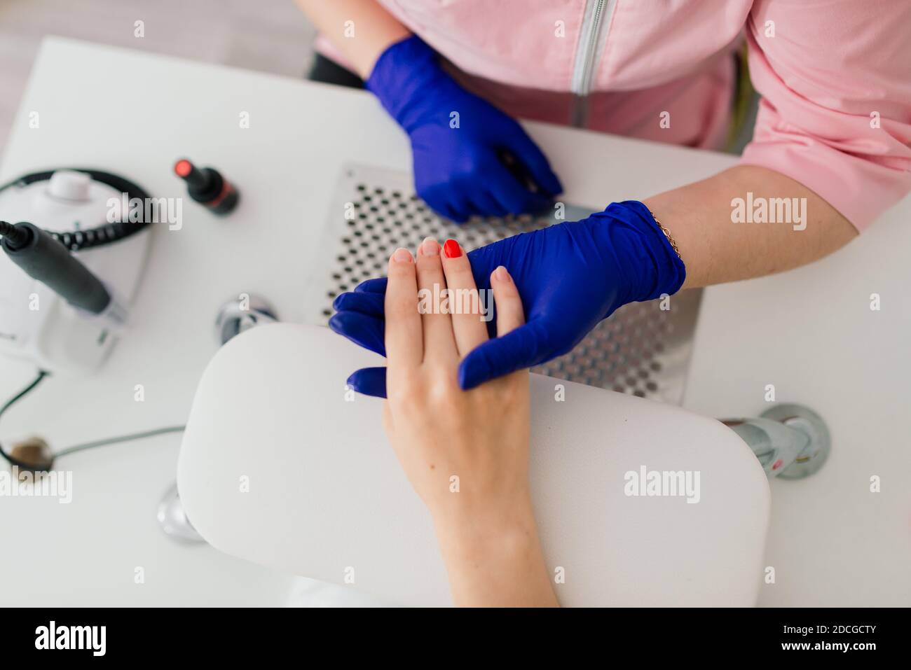 Female manicure master in beauty salon work with hands of the client ...