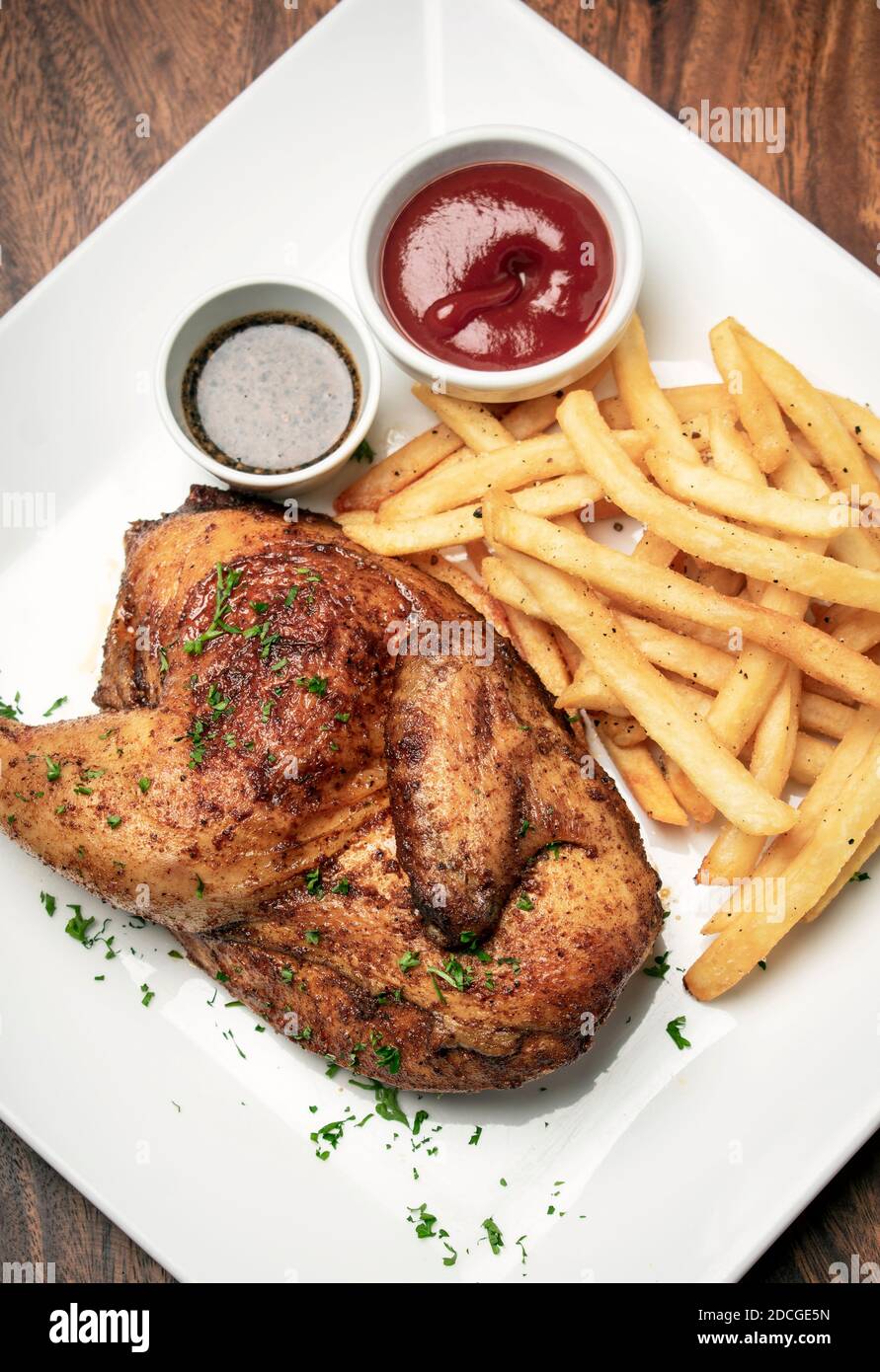 roast rotisserie half chicken with french fries simple meal on wood ...