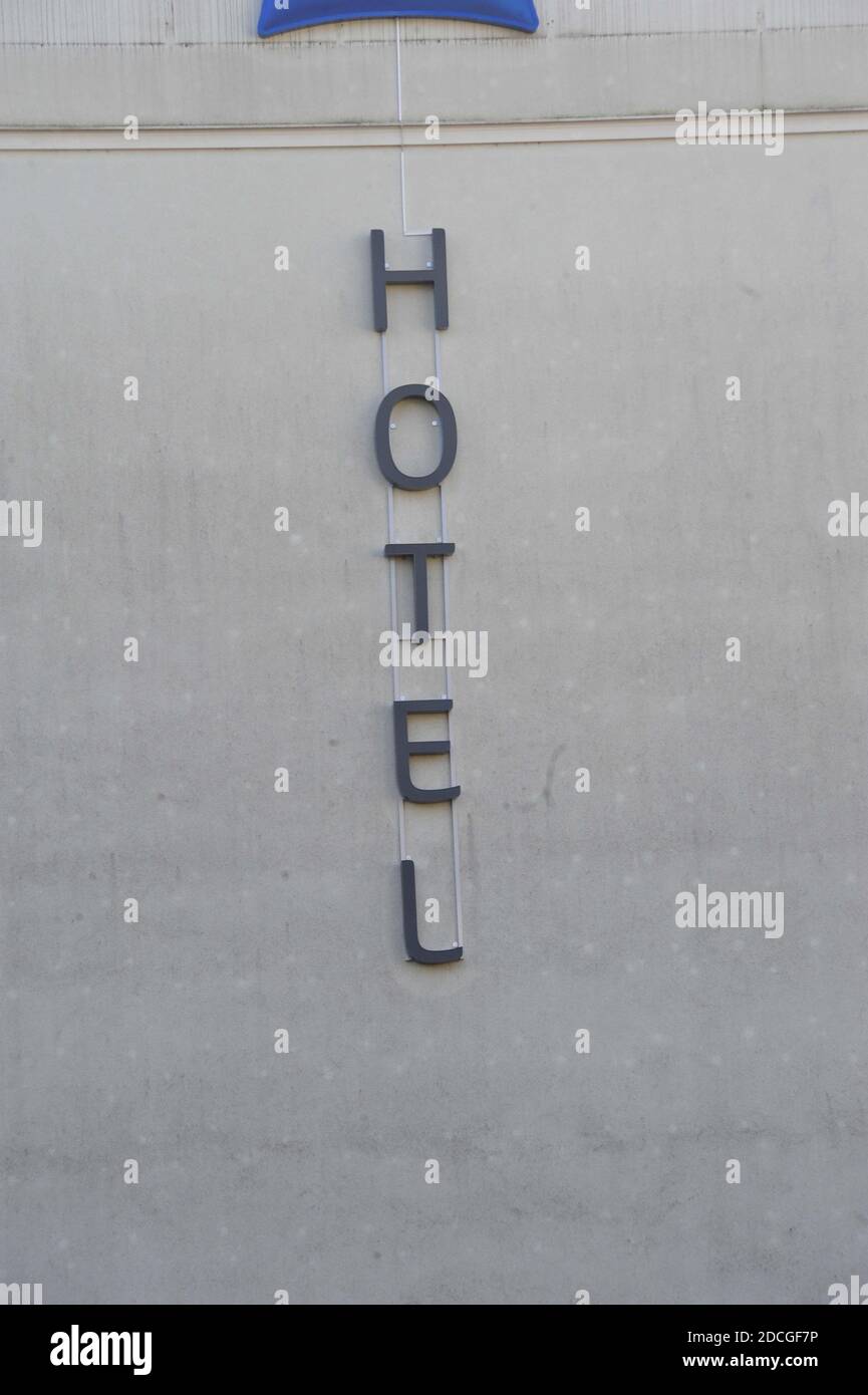 a simple and black Hotel sign on a concrete wall Stock Photo - Alamy
