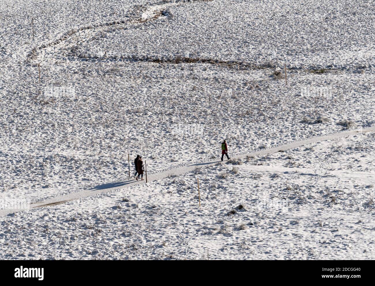 Spitzingsee, Germany. 21st Nov, 2020. Visitors walk through the snow ...