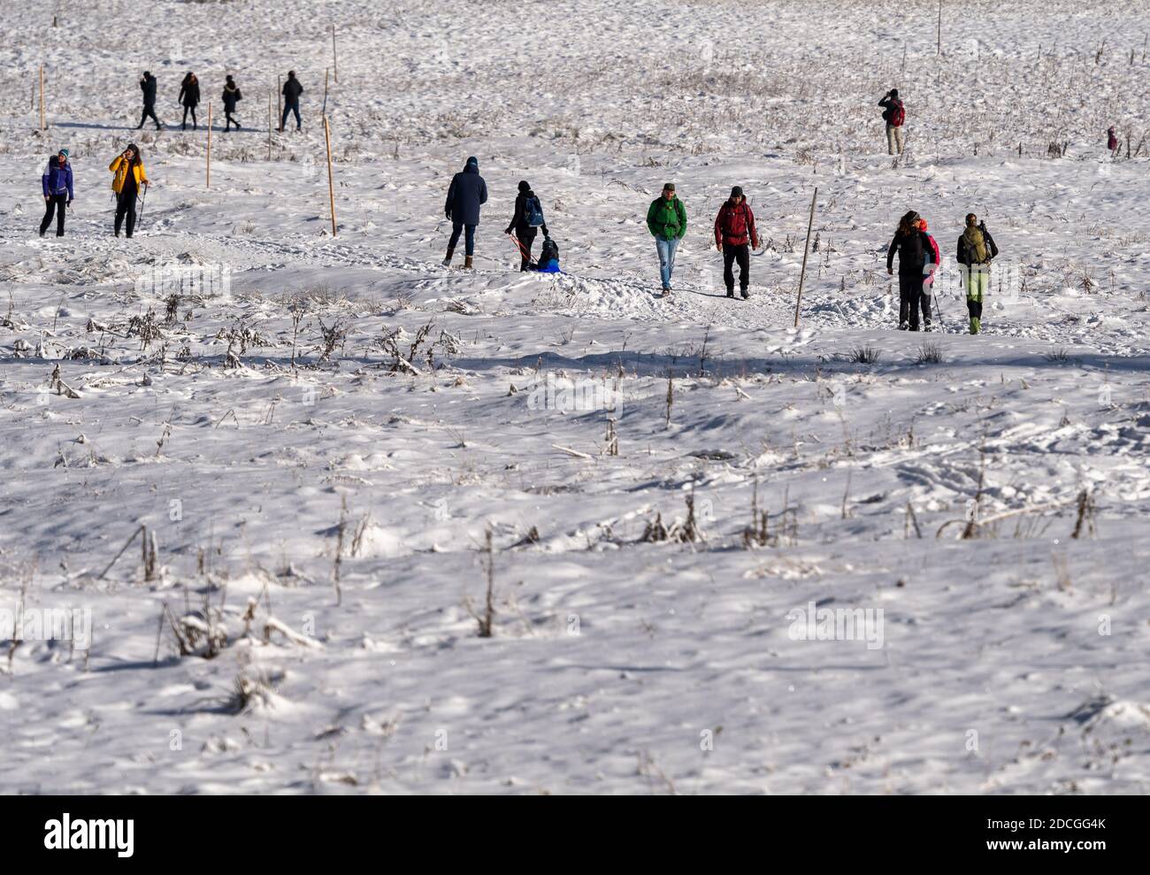 Spitzingsee, Germany. 21st Nov, 2020. Visitors walk through the snow ...