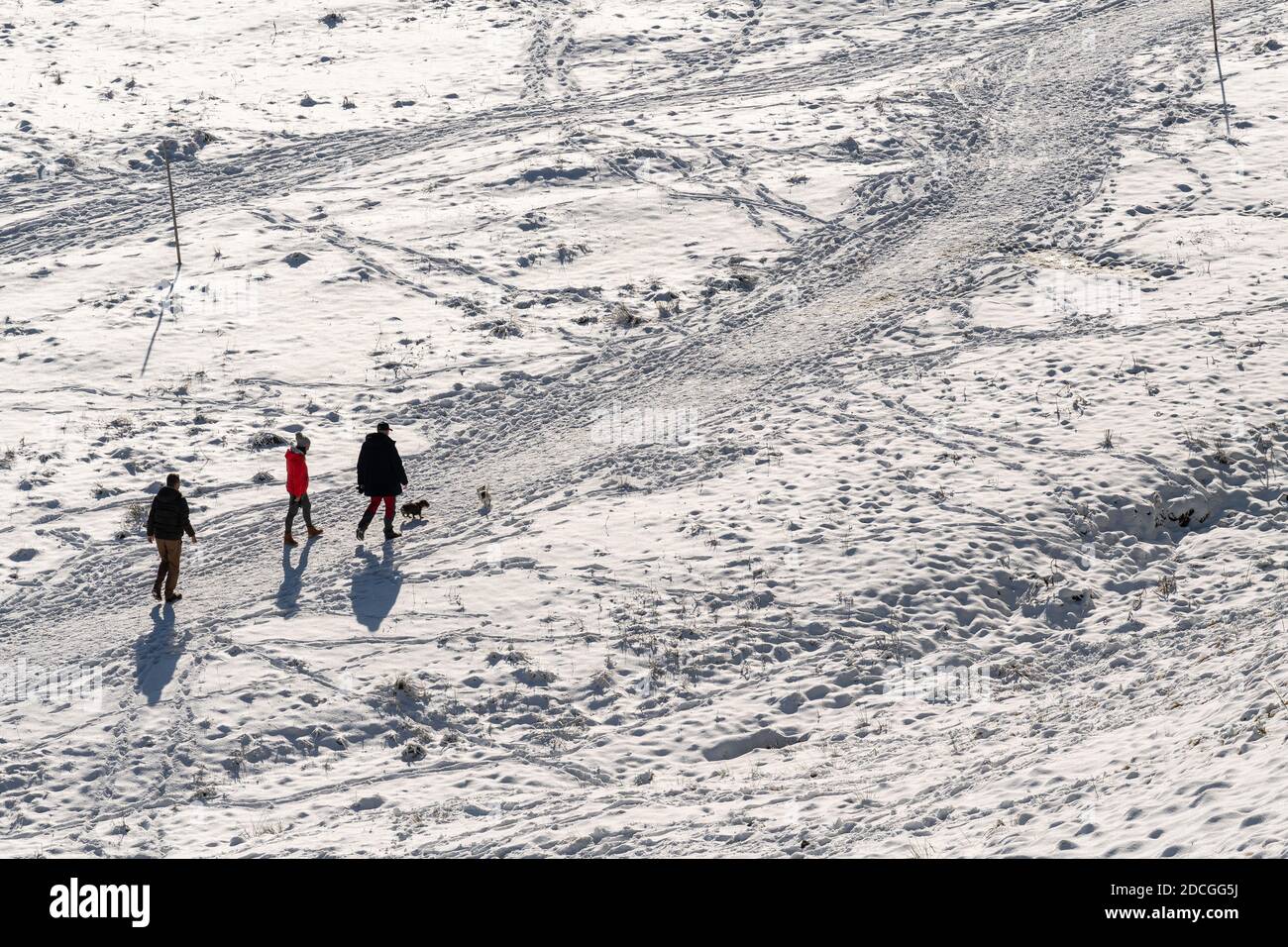 Spitzingsee, Germany. 21st Nov, 2020. Visitors walk through the snow ...