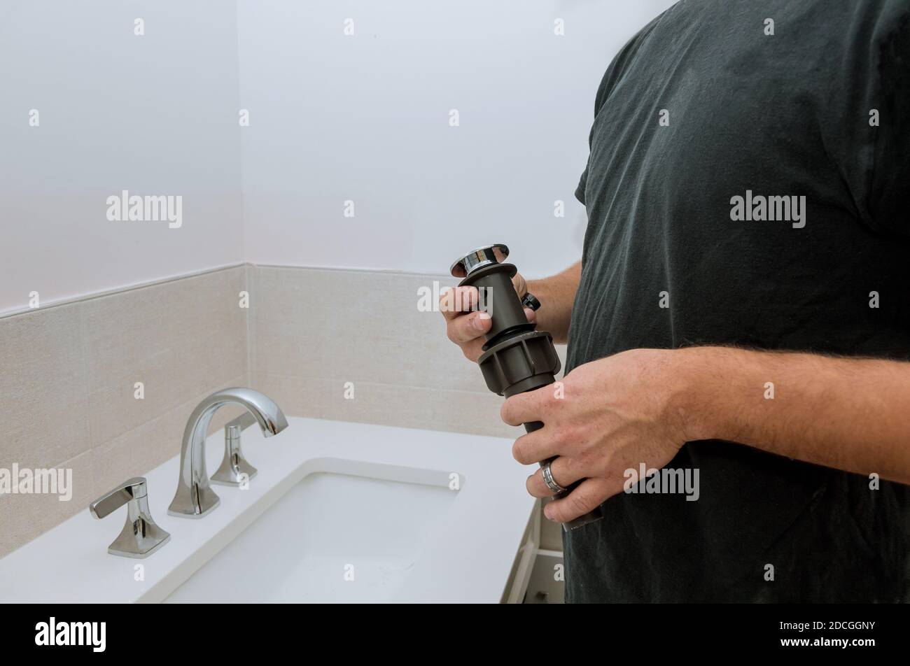Hands man mounted sewer drain with a sink at work in a bathroom Stock ...