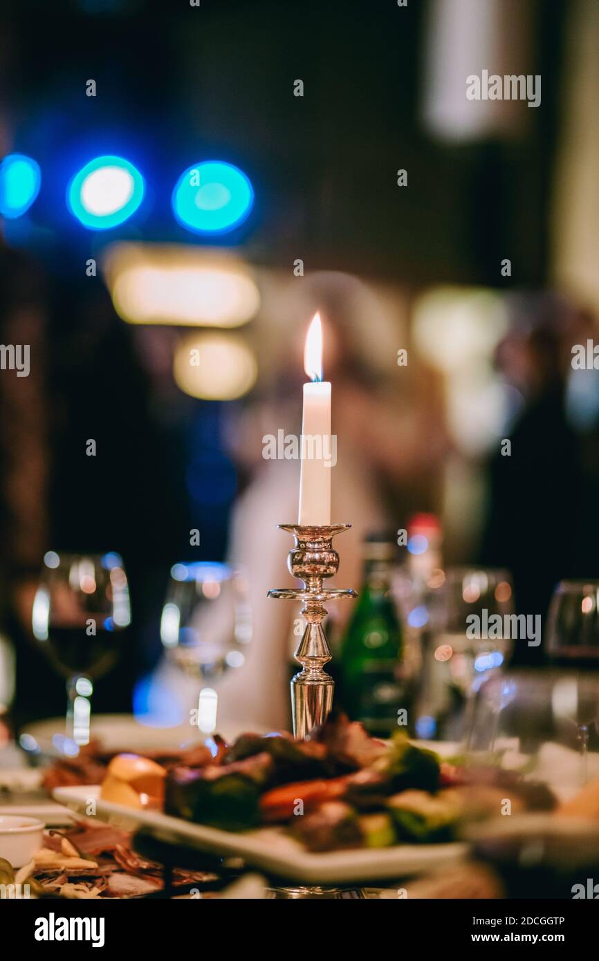 A dining table with tasty food and candle in restaurant Stock Photo - Alamy