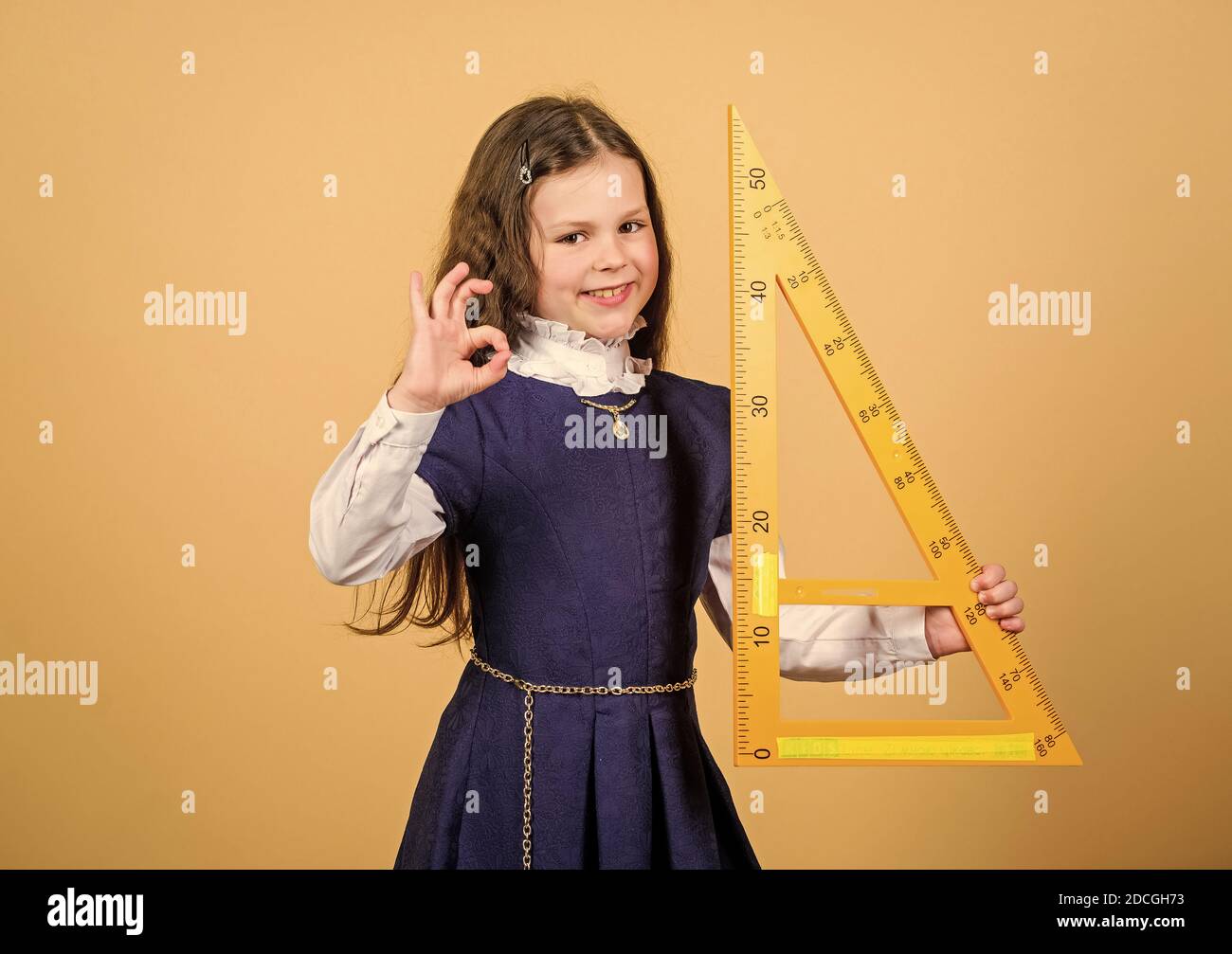 Smart and clever concept. Pupil cute girl with big ruler. School ...