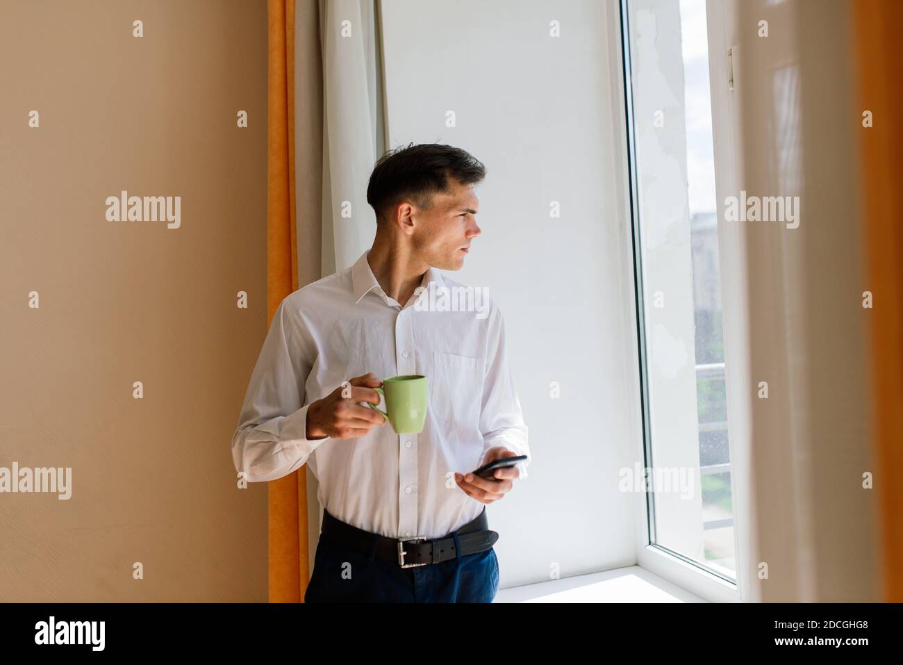 Relaxed young man resting from work. Man enjoy break stretching in home ...
