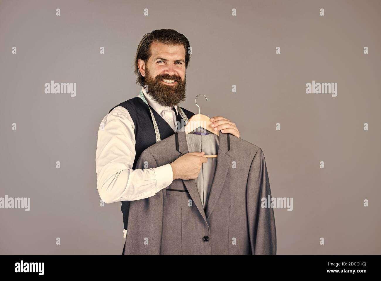 Working on new design. tailor in his workshop. Handsome bearded fashion ...