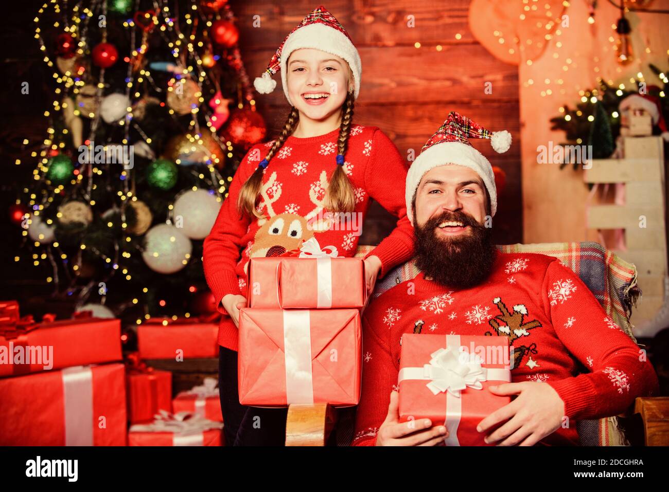 Santa Claus is real. Father and daughter wearing Santa Claus hats ...