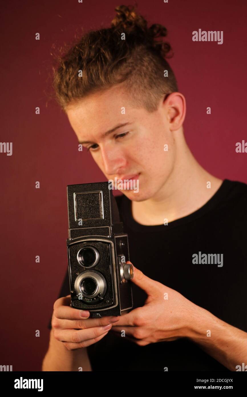 Young photographer with old, retro camera Stock Photo - Alamy