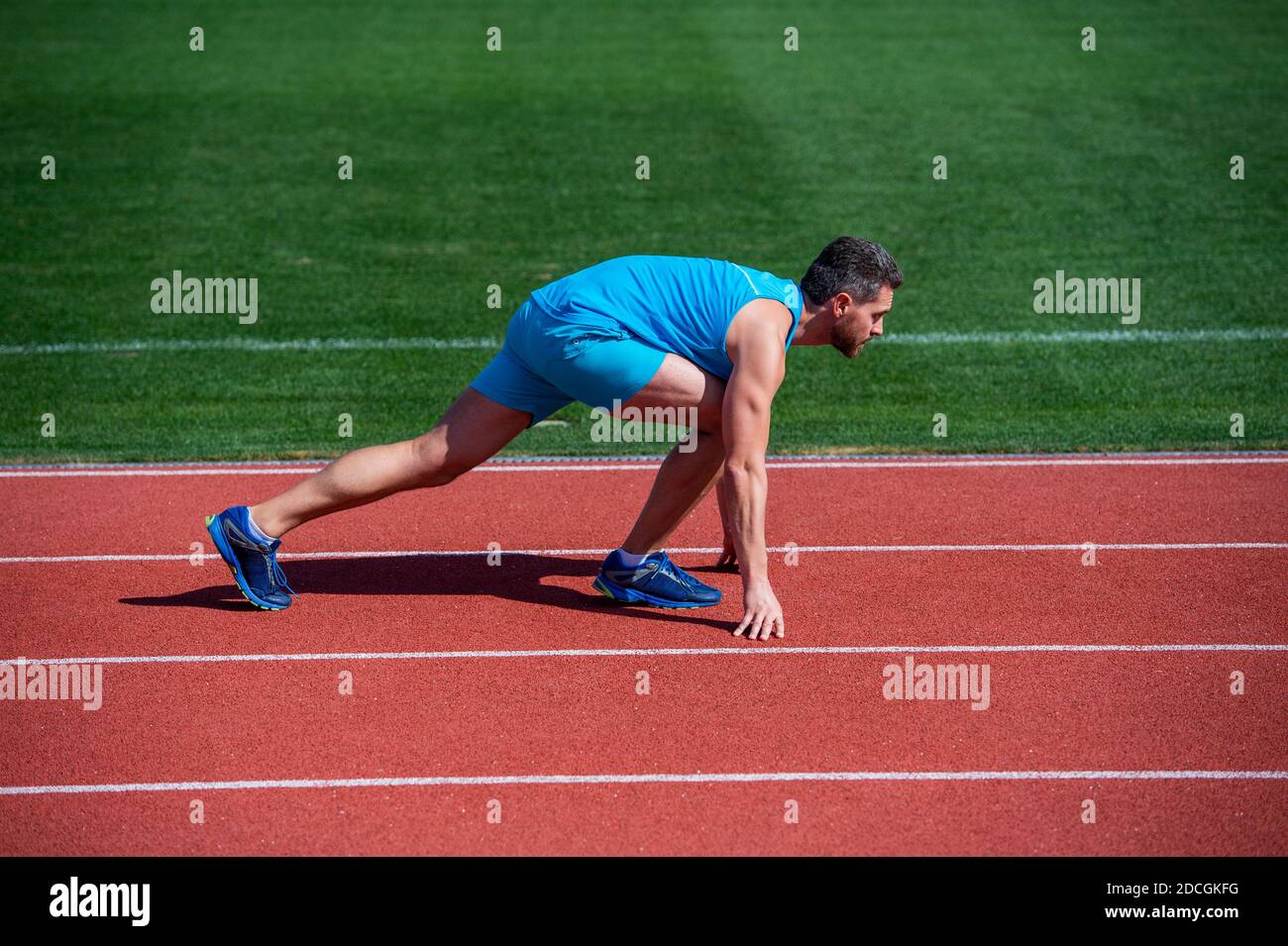energy. muscular guy start to run. man running on stadium. sports and ...