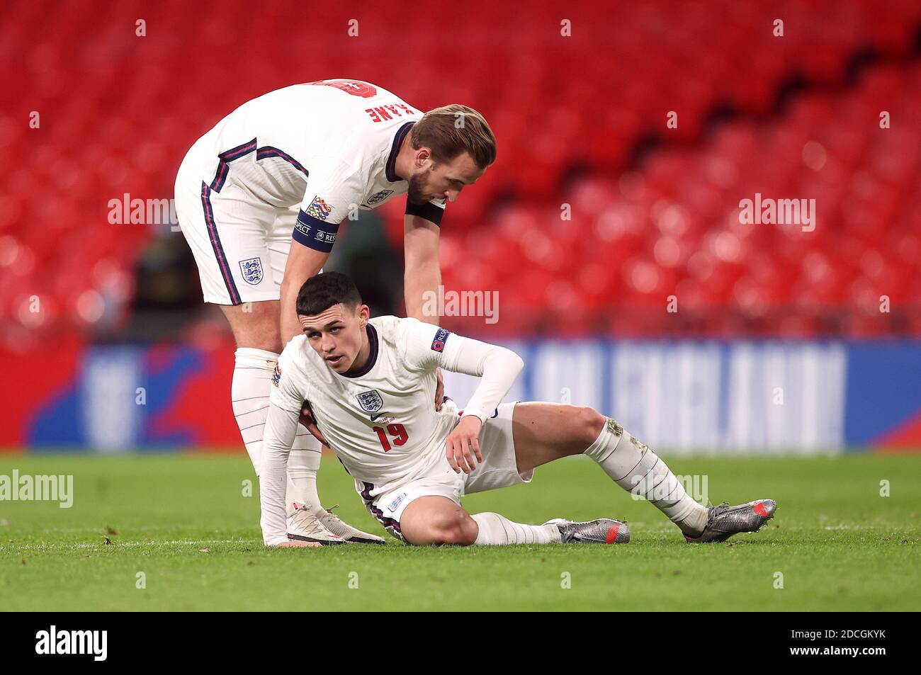 England's Phil Foden is helped up by Harry Kane during the UEFA Nations ...