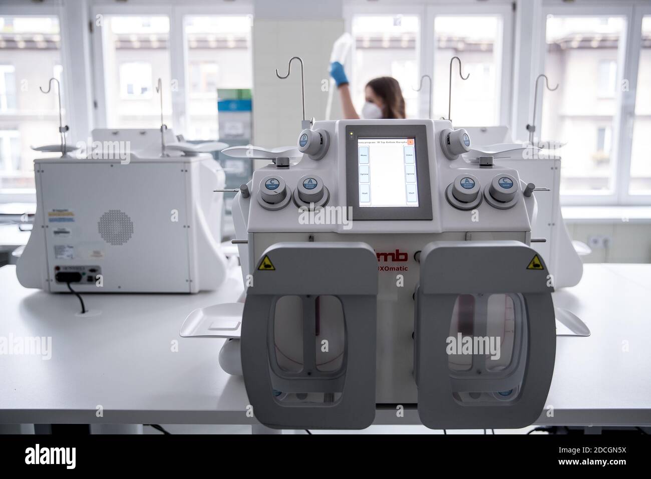 A medical technician at work processing blood plasma from COVID-19 ...