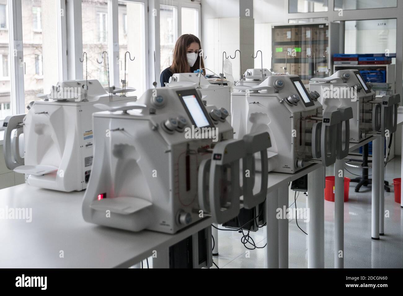 A medical technician at work processing blood plasma from COVID-19 ...