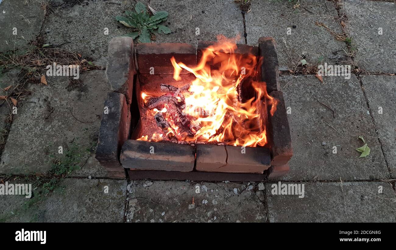 Mangal built from old burnt bricks on ground covered with cement square ...