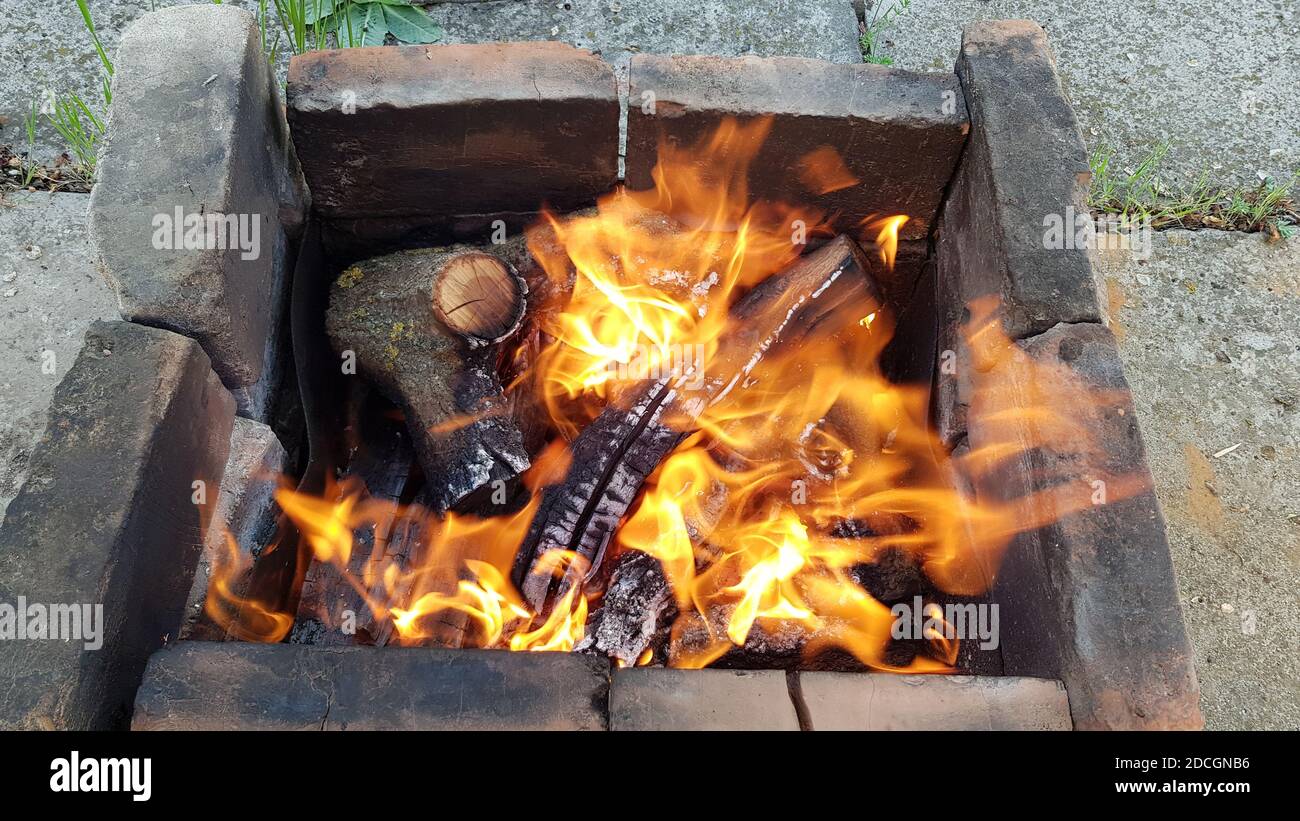 Fire is flaming in windy weather. Blazing bonfire closeup. Picnic ...
