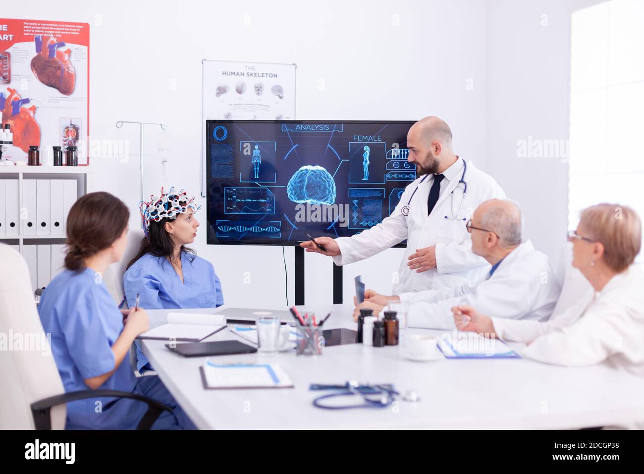 Female nurse wearing scaning headset for brain activity during ...