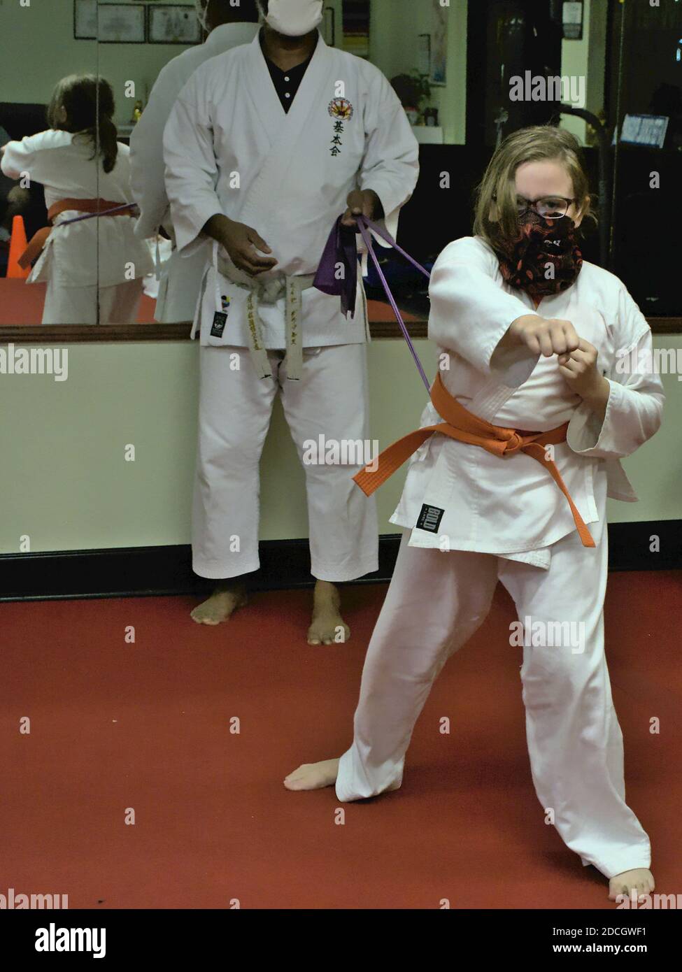 A picture of my child practicing Karate in her karate class. She is ...