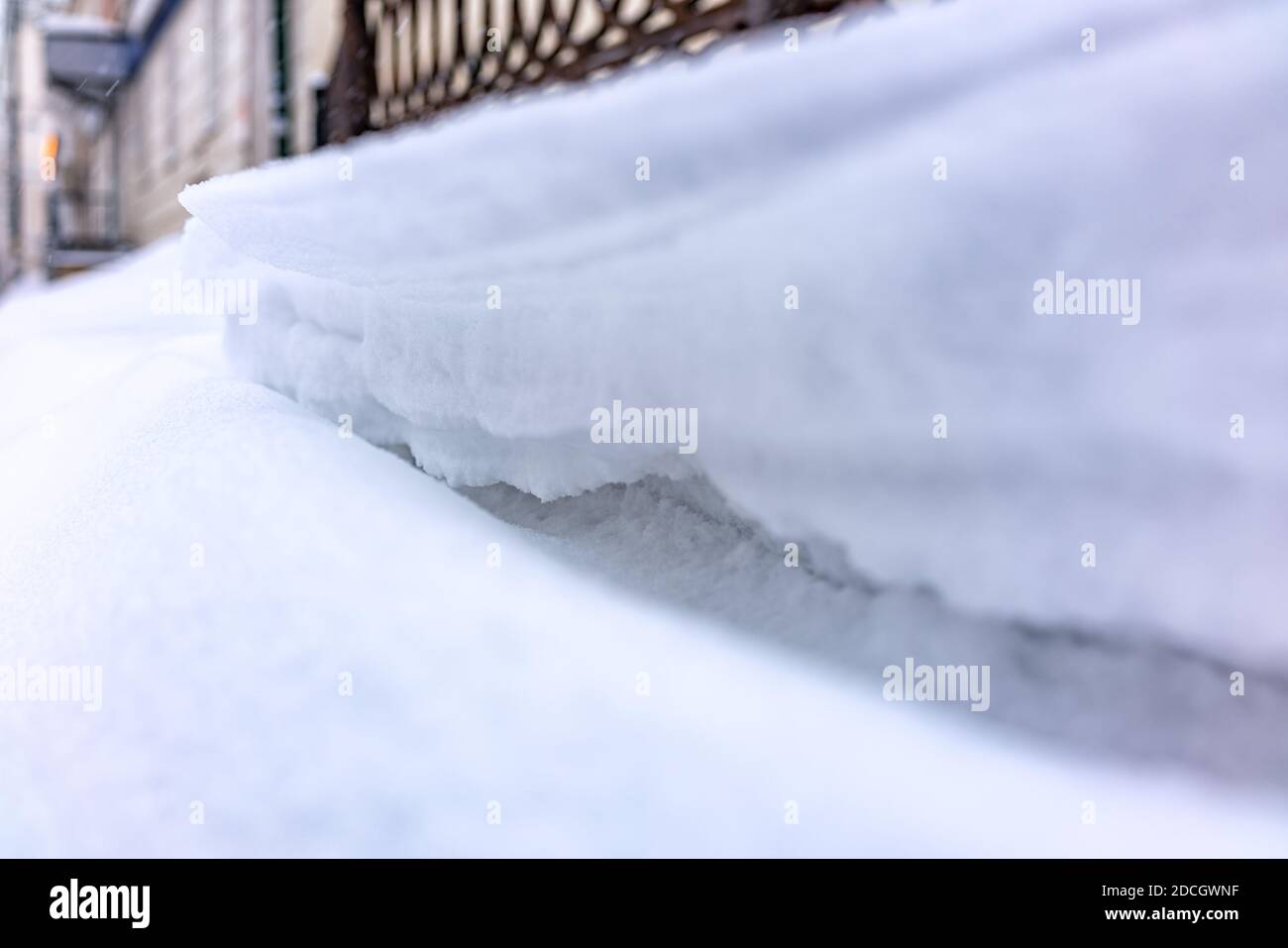 Deep snowdrift in the city. Abstract snow background. City road in ...