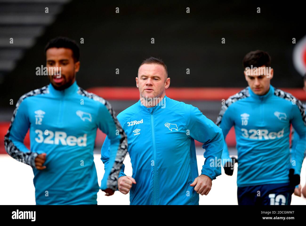 Derby County's Wayne Rooney (centre) warms up on the pitch prior to the ...