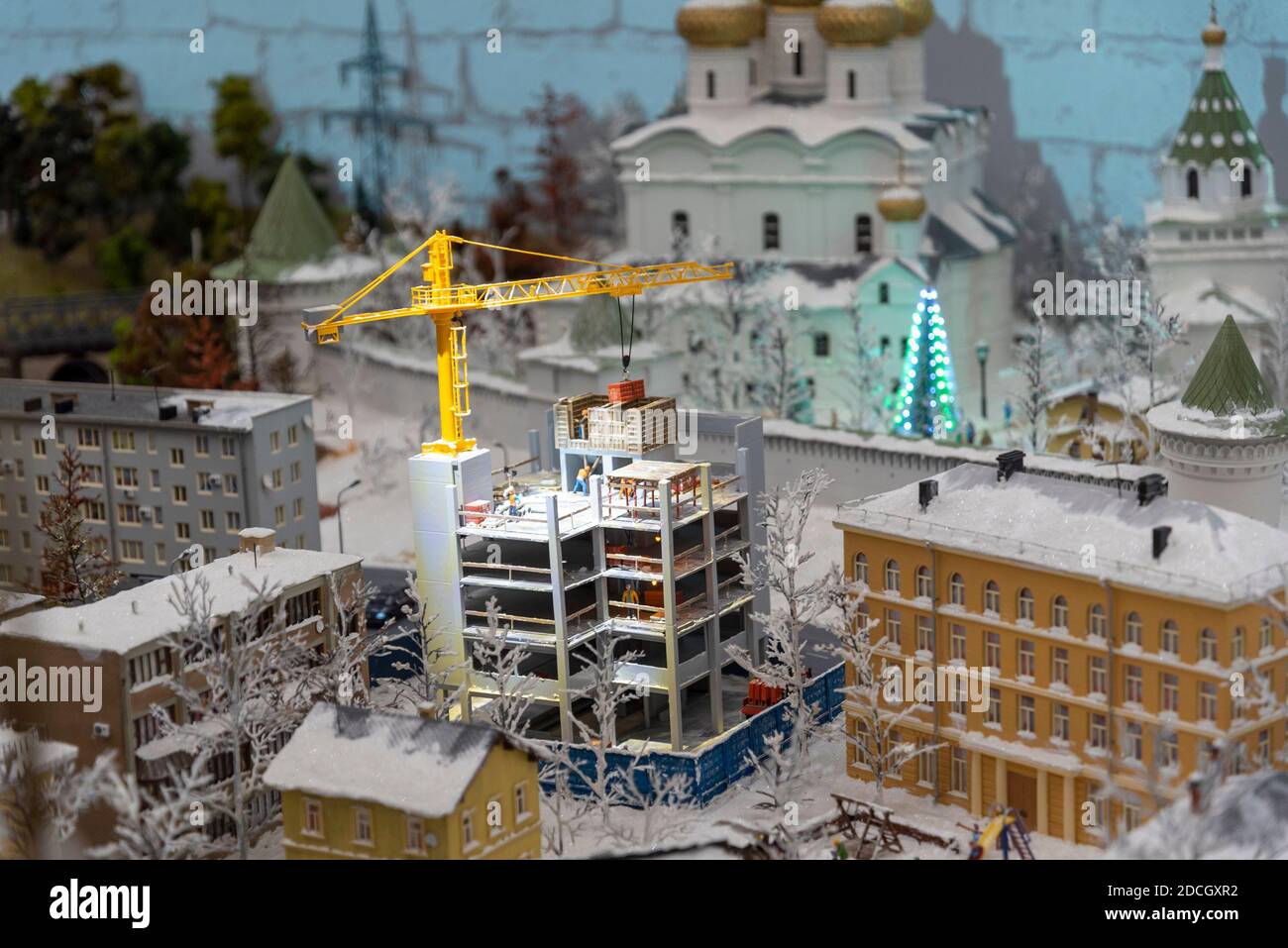 Miniature construction of a high-rise building with a tower crane. The ...
