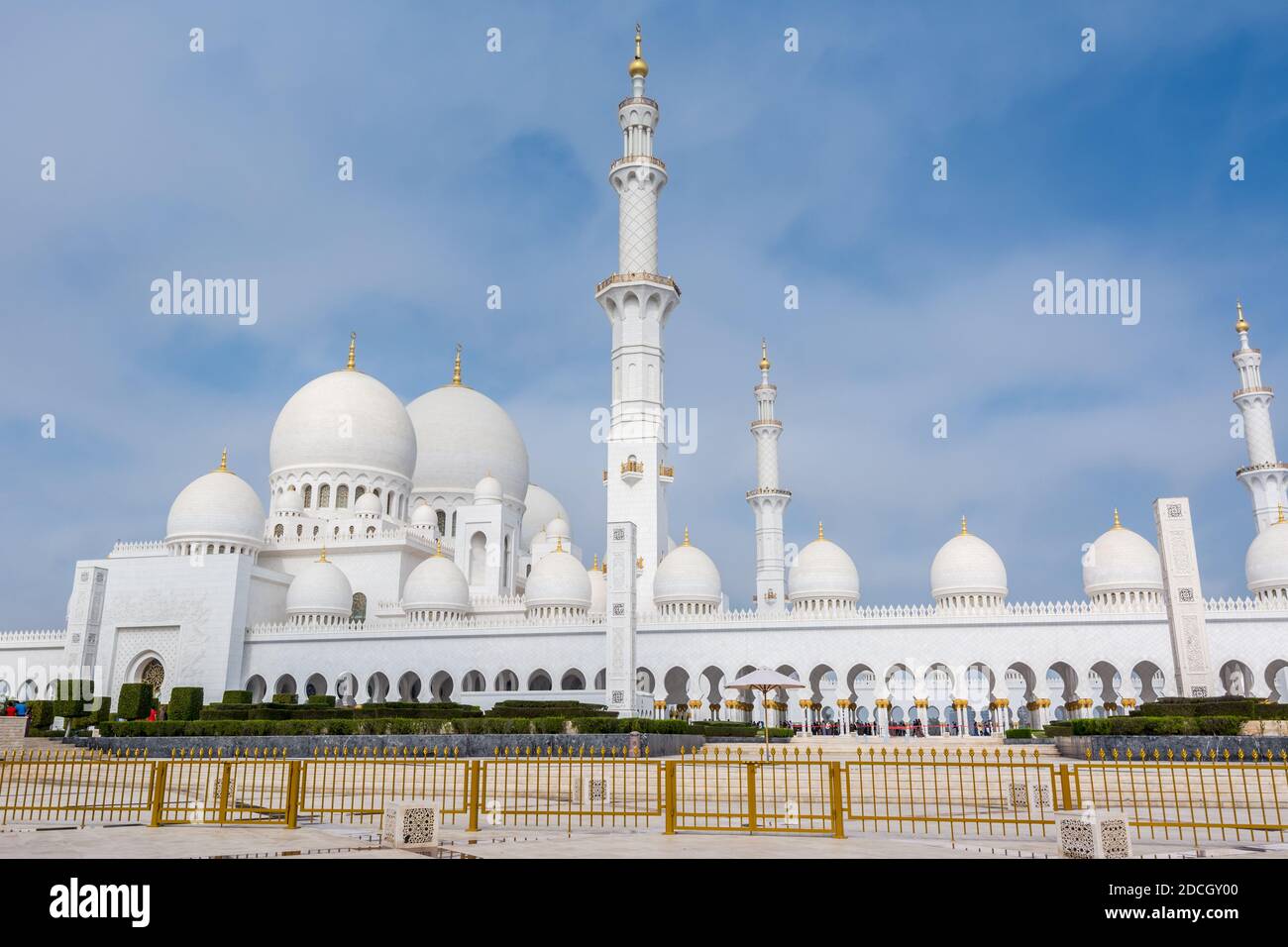 Panorama of White Grand Mosque with fence against blue sky, also called ...