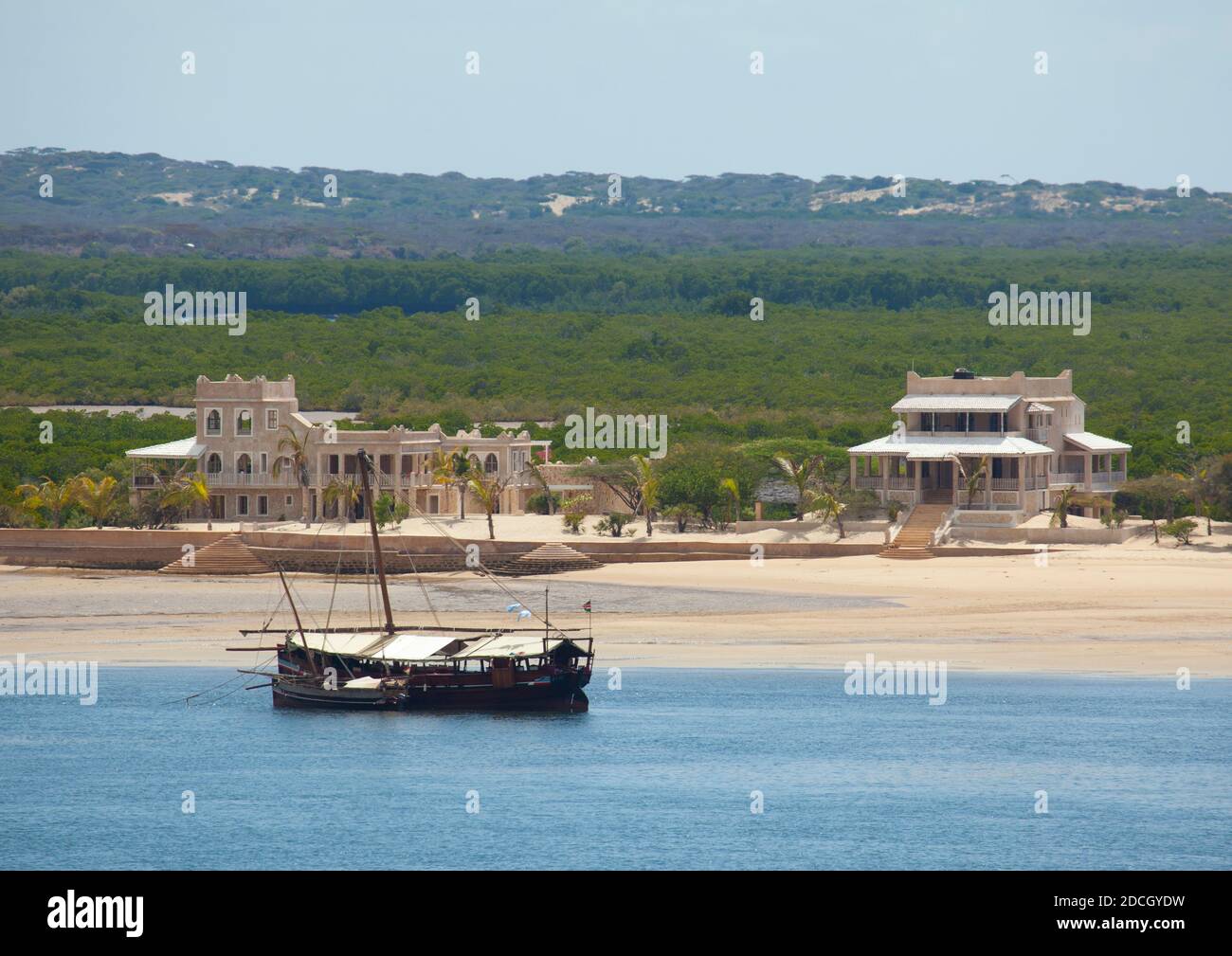 Dhow mooring along the beach in front of luxury villas, Lamu County ...