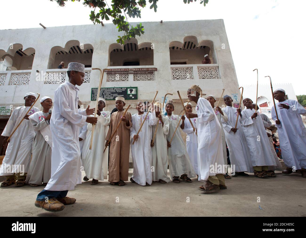 Muslim men singing and dancing with goma sticks during Maulid festival ...