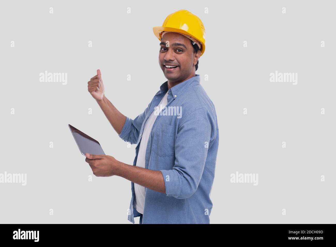 Construction Worker Holding tablet in Hands Showing Back. Man Using ...