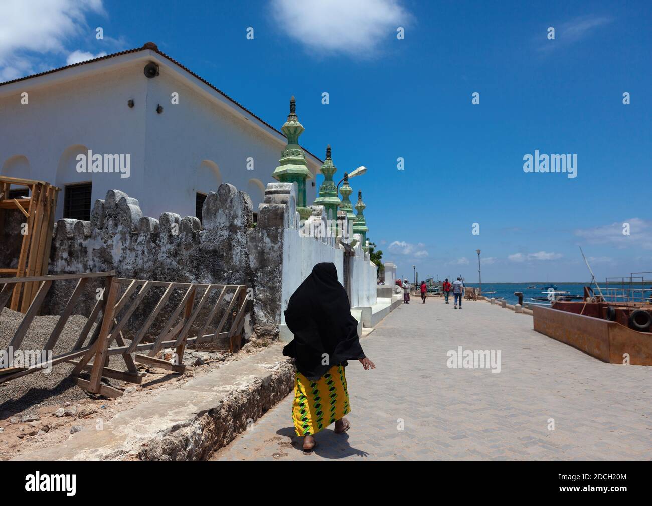 Muslim woman passing in front of a mosque, Lamu County, Lamu, Kenya ...