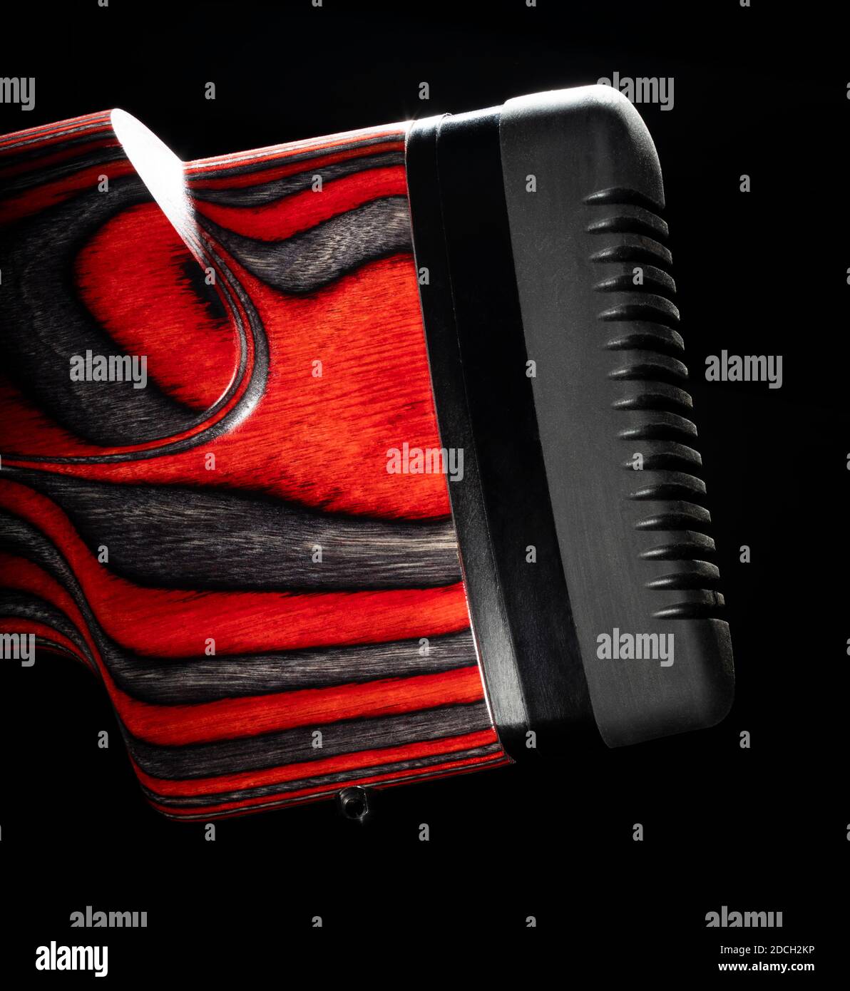 Recoil pad on a rifle with a red and black laminated stock on black ...