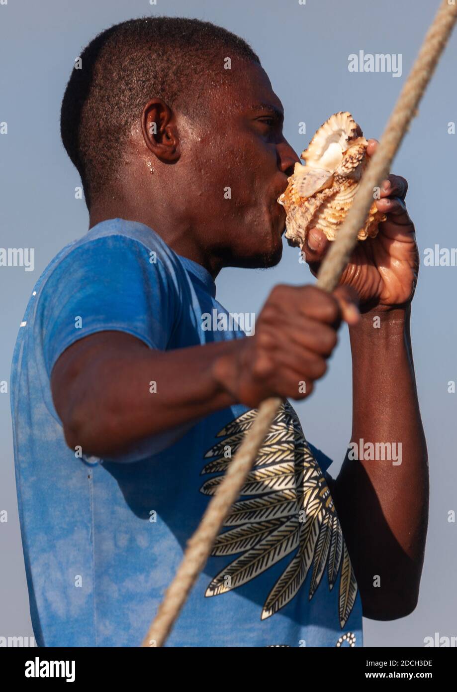 Man blowing shell hi-res stock photography and images - Alamy