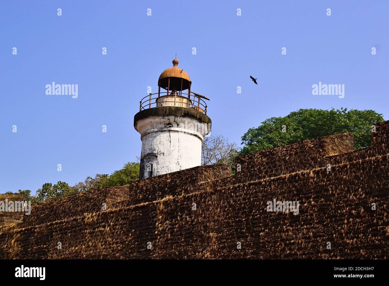 Old colonial lighthouse and old fortress wall of Tellicherry Fort ...