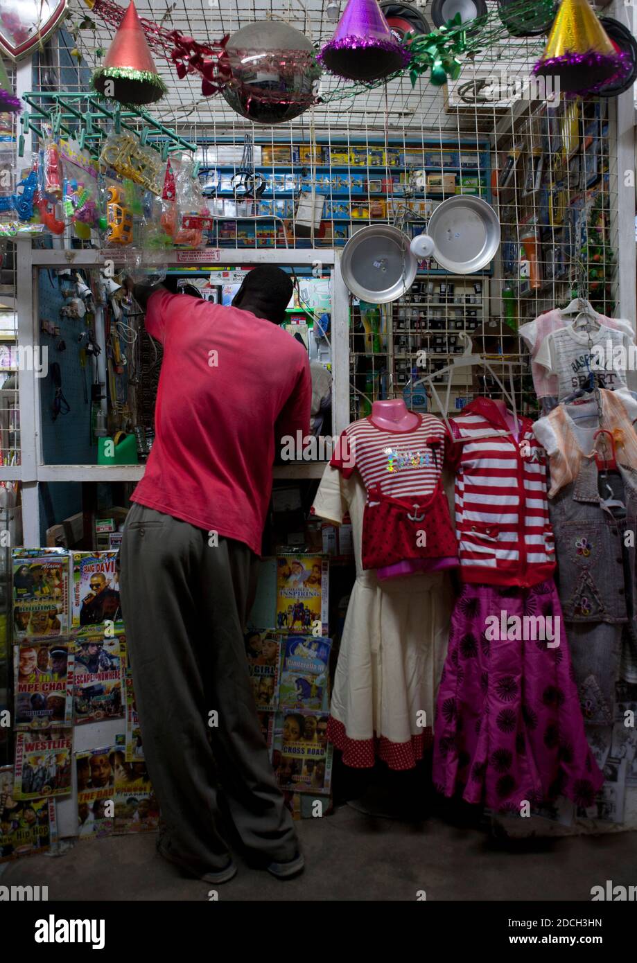 Man buying goods at a shop counter, Lamu County, Lamu, Kenya Stock ...