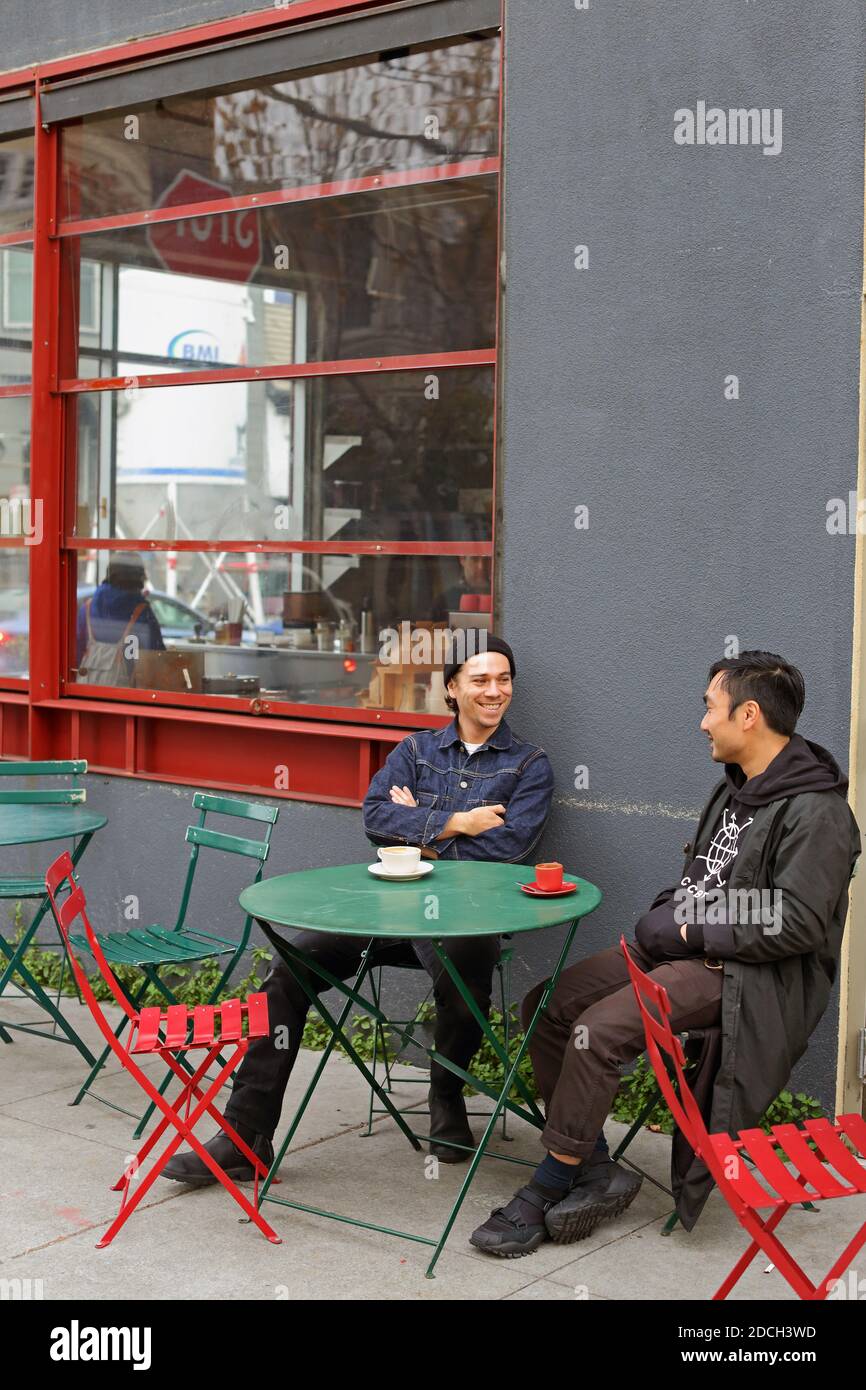 UNITED STATES / California Two young man sitting outside Linea espresso ...