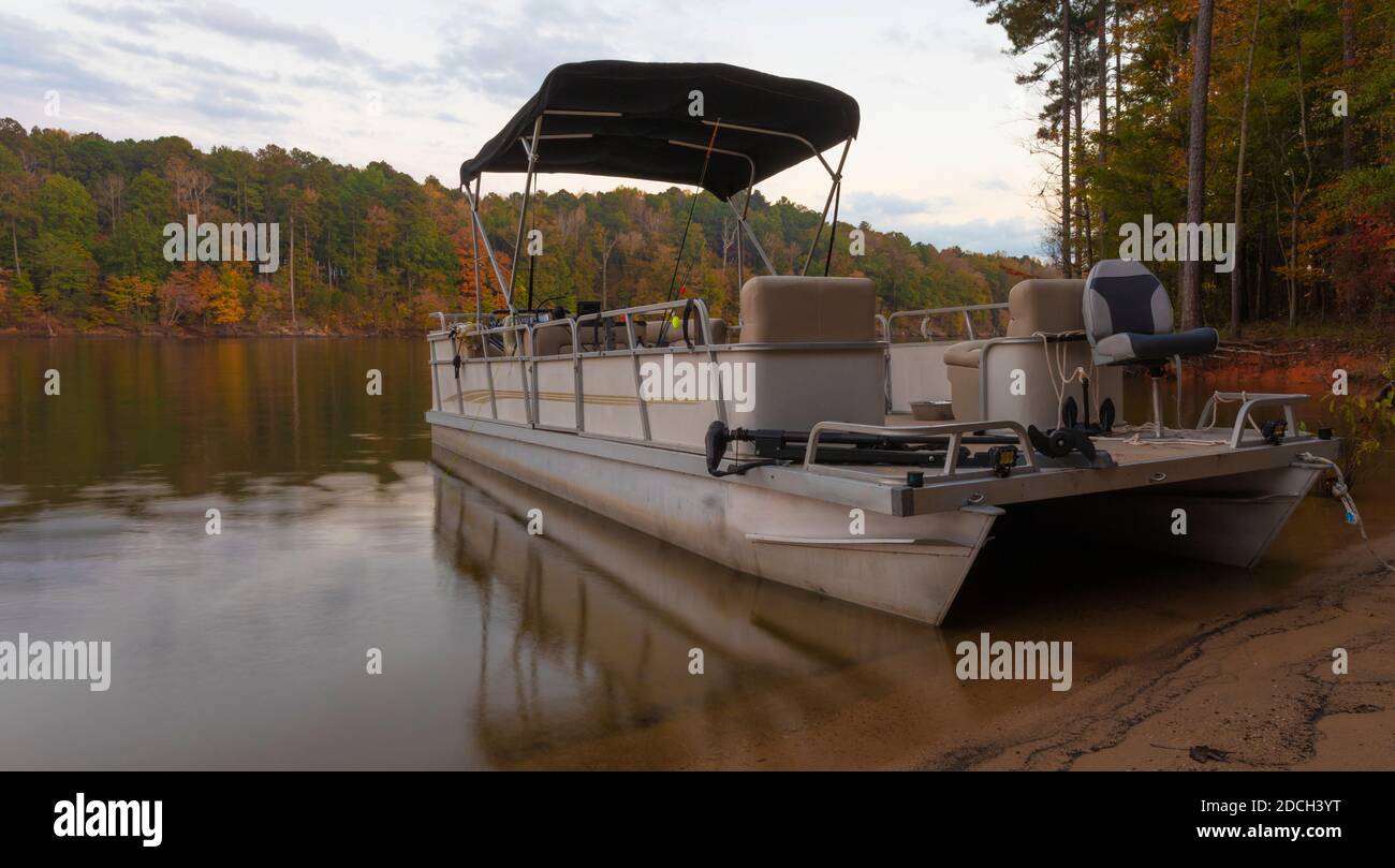 Pontoon boat beached on the shore of Falls Lake in Autumn Stock Photo ...